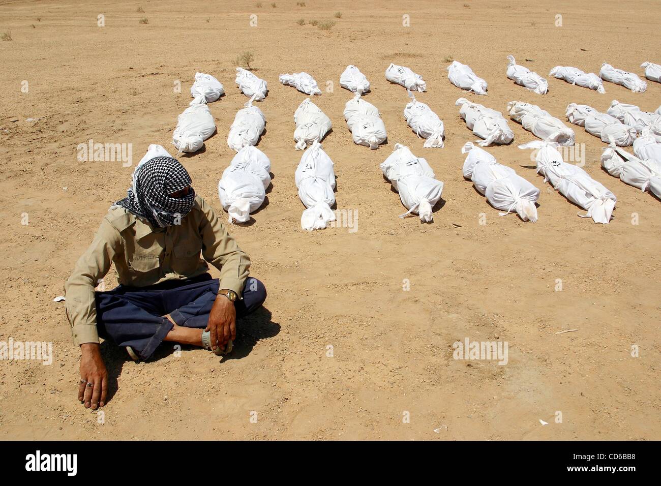 May 24, 2003 - Al-Musayab, Iraq - An array of shroud-wrapped remains ...