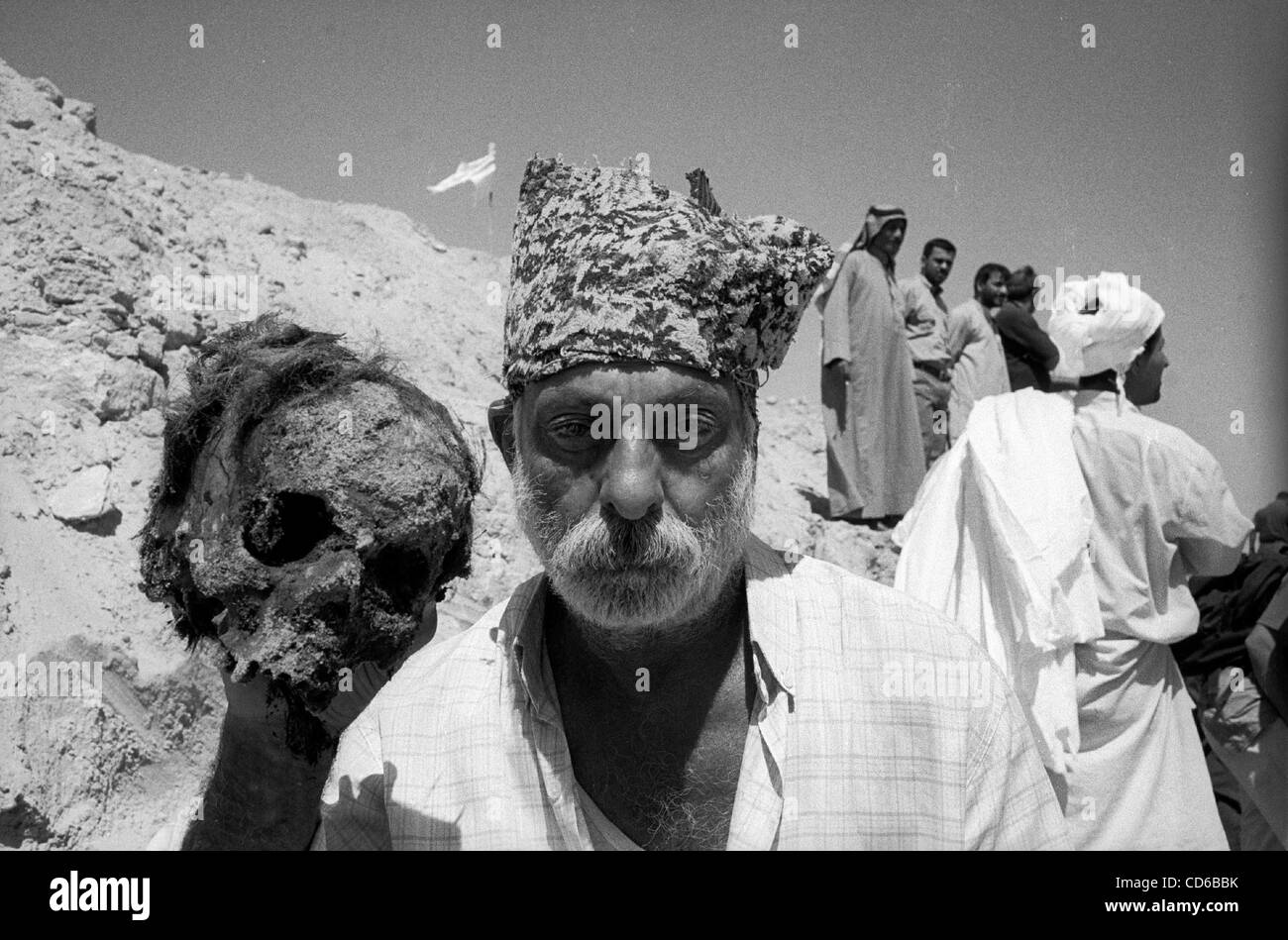 May 24, 2003 - Al-Musayab, Iraq - A man posed with a skull in a mass ...