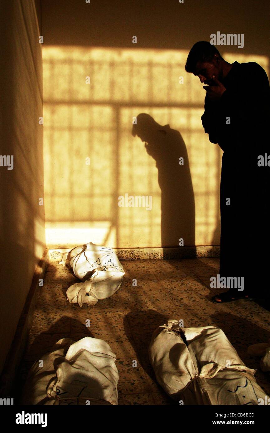 May 28, 2003 - Al-Musayab, Iraq - An Iraqi man looks at the shrouded ...