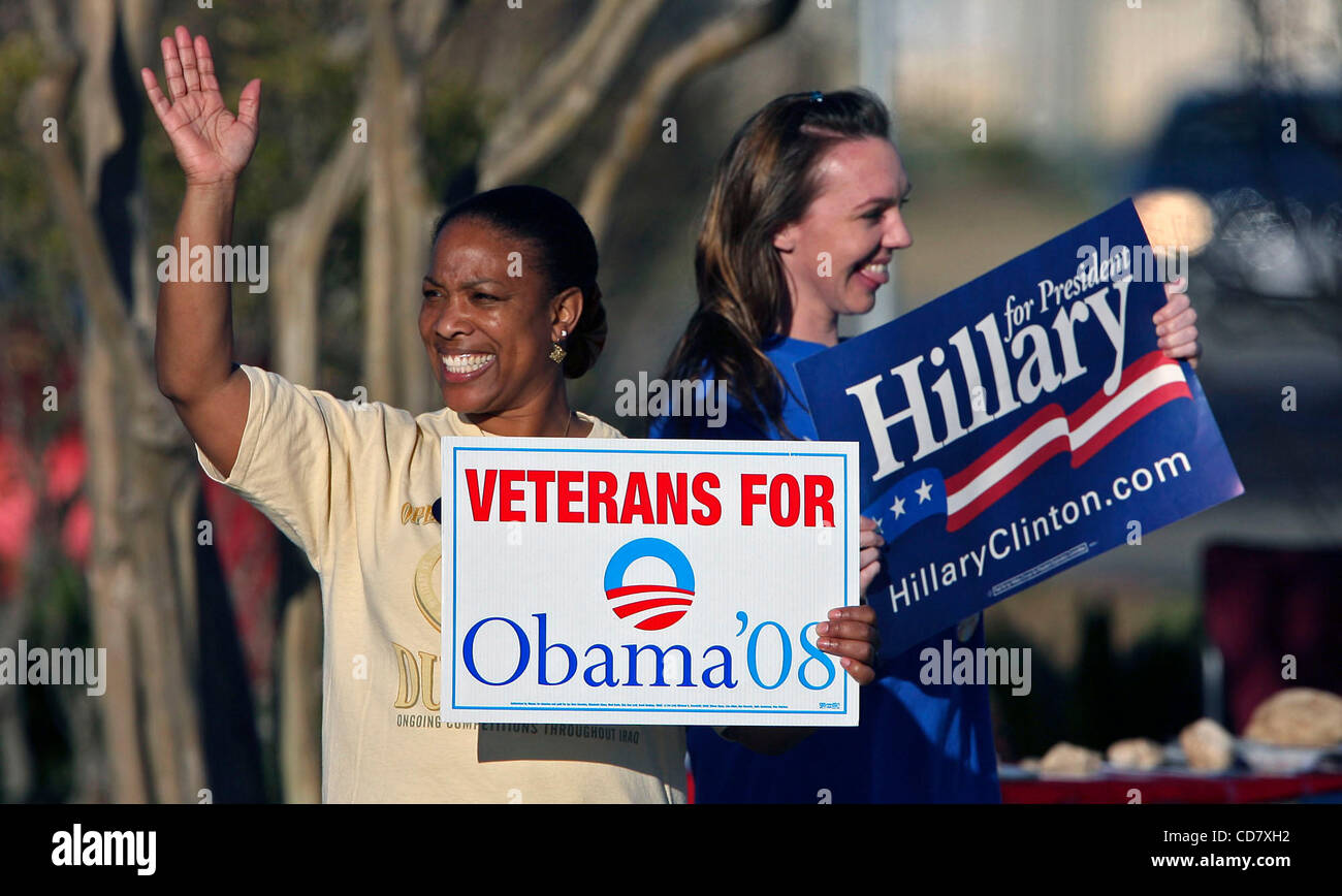 METRO Danielle Griffin (left) waves to motorists as she stands with ...