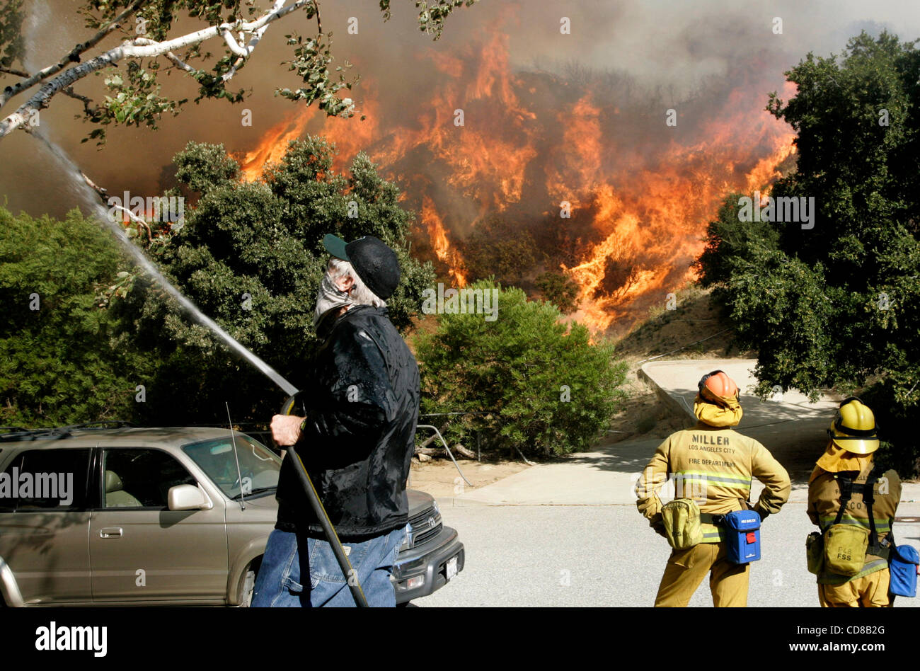 Oct 14, 2008 - Granada Hills, California, USA - Firefighters keep an ...