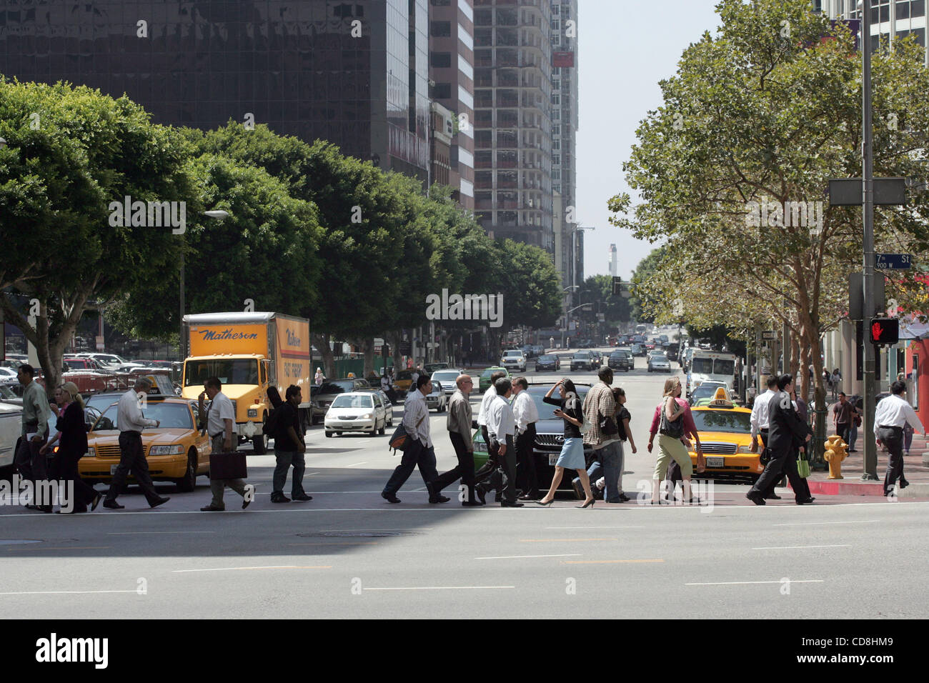 People cross the street at noon in downtown Los Angeles. (Photo by ...