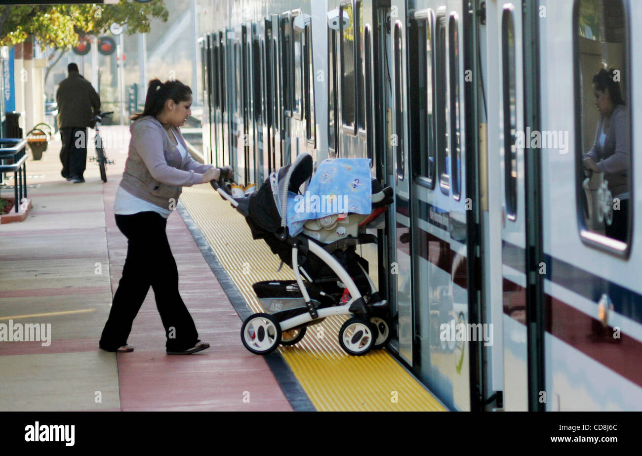 A passenger boards light rail at the Santa Teresa Blvd. train station ...