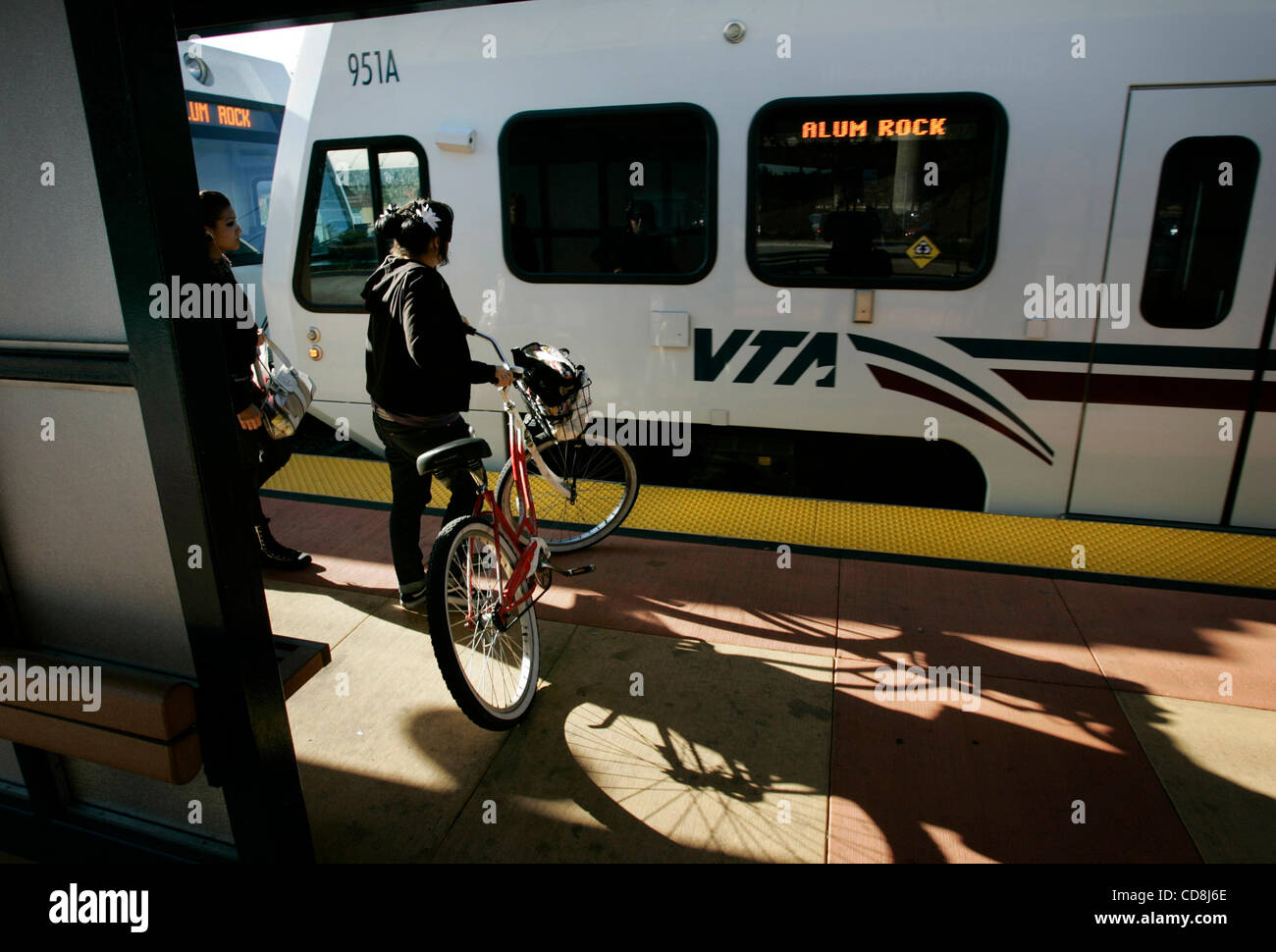 Passengers wait to board light rail at the Santa Teresa Blvd. train ...