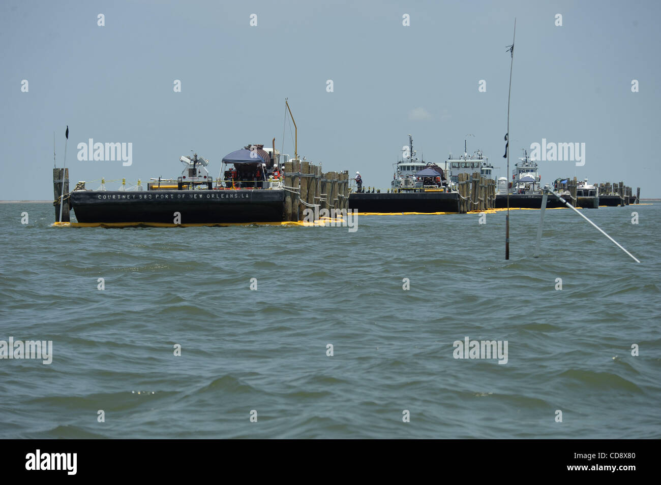 Barge dam build to keep oil out of Barataria Bay just east of Grand ...