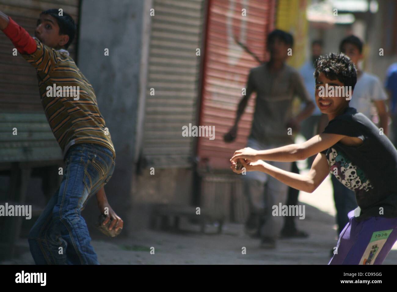Young men throw stones hi-res stock photography and images - Alamy