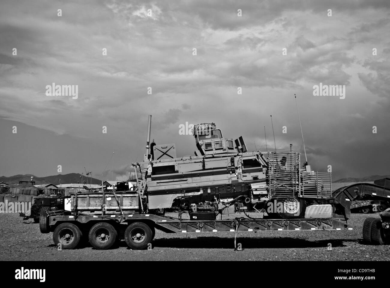 A mine-resistant, ambush-protected vehicle sits on a flat-bed trailer ...