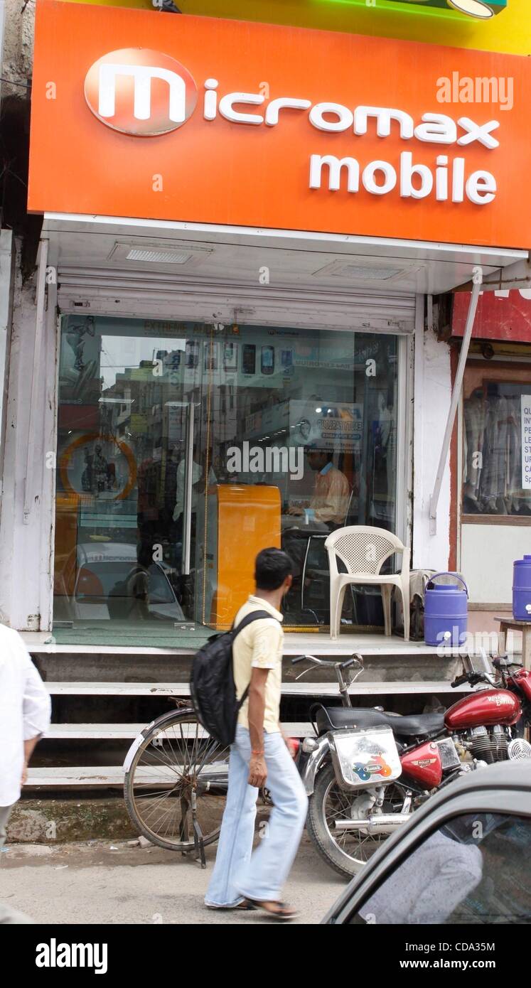 Aug 03, 2010 - Mumbai, India - A man looks in the window of a Micromax ...