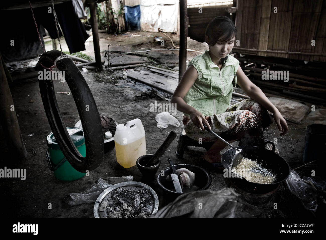 Karen refugee woman cooking fried bakery to sell on the muddy ways onto ...