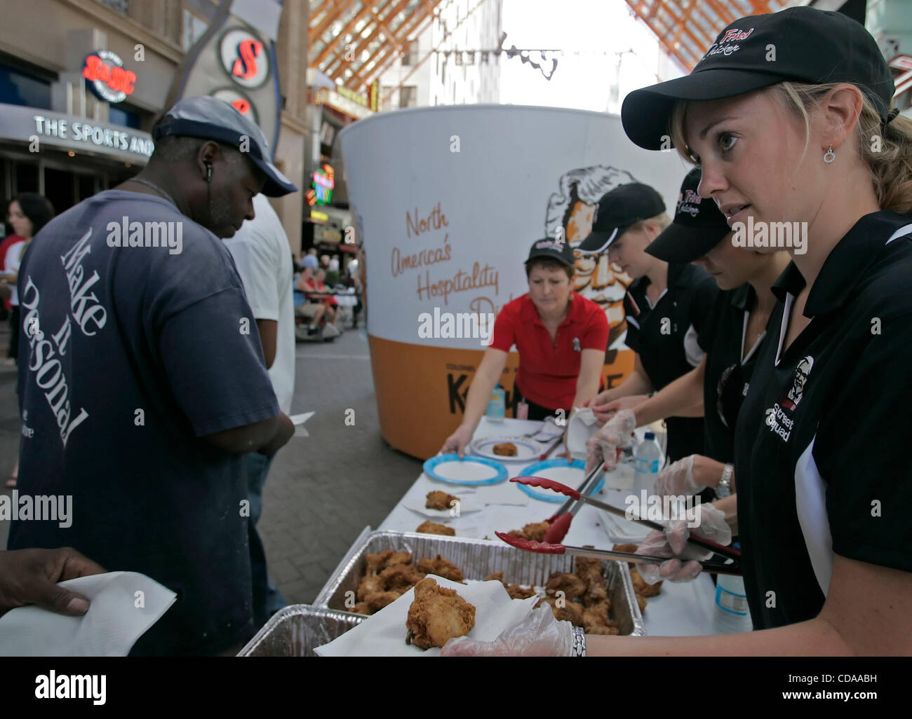 KFC employee KATIE NASH (right) serves free pieces of fried chicken on ...