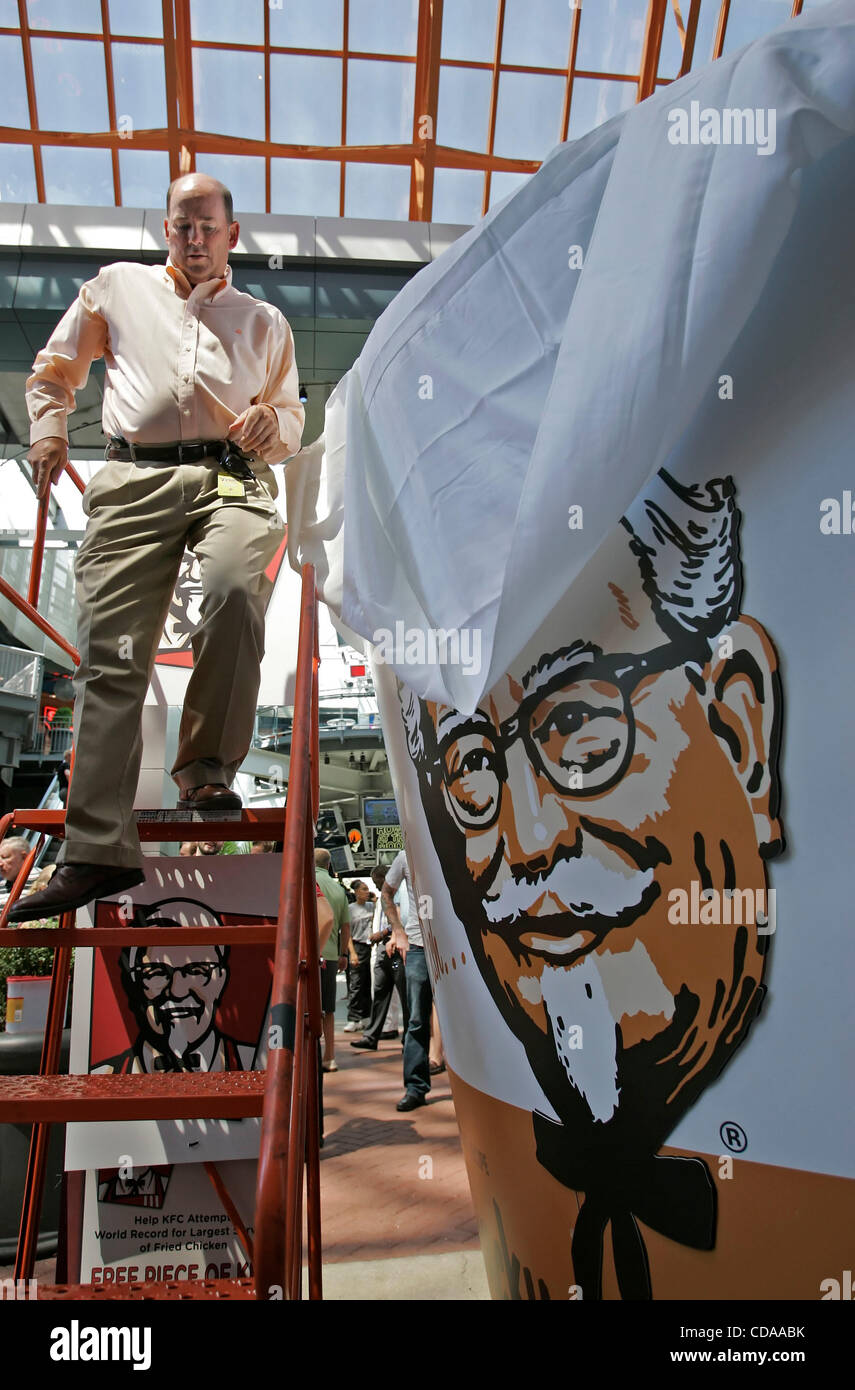 CLIFF STEPP climbs down a ladder after covering a world record-breaking 8-foot-tall bucket of ...