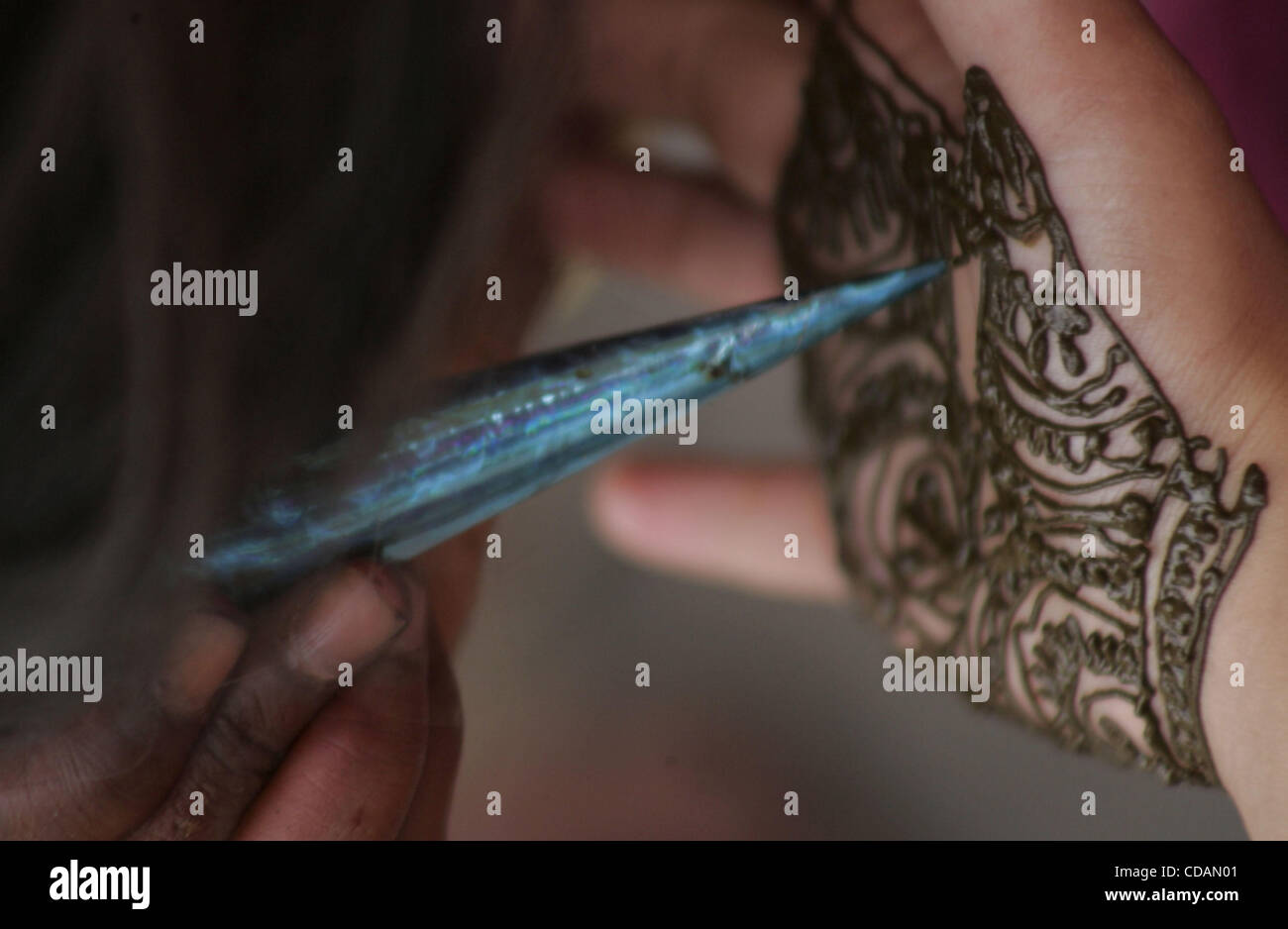 A kashmiri muslim gets her hand decorated with henna ahead of Eid-al ...