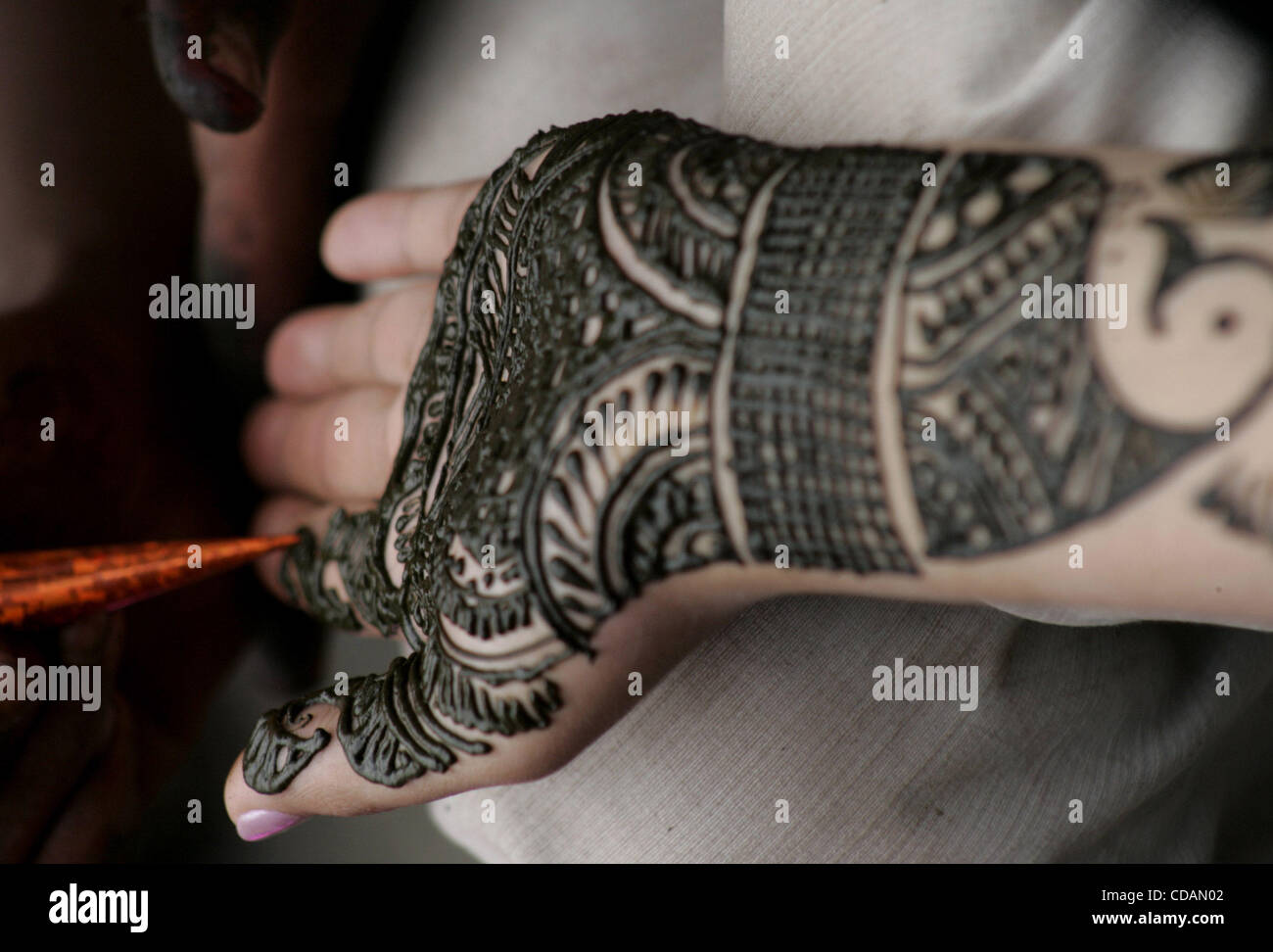 A kashmiri muslim gets her hand decorated with henna ahead of Eid-al ...