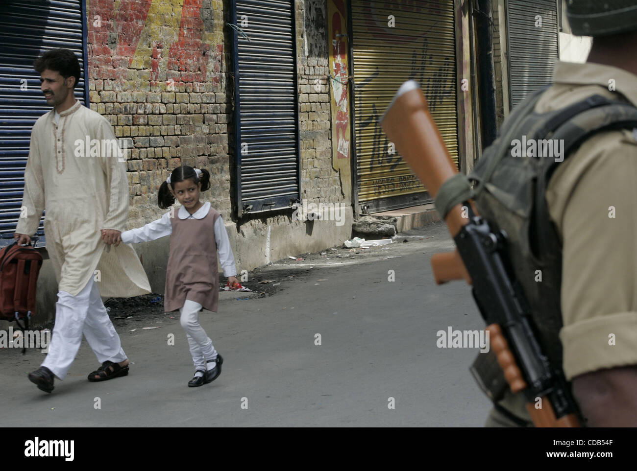 Indian policemen stand guard as kashmiri muslim Student on their way to ...