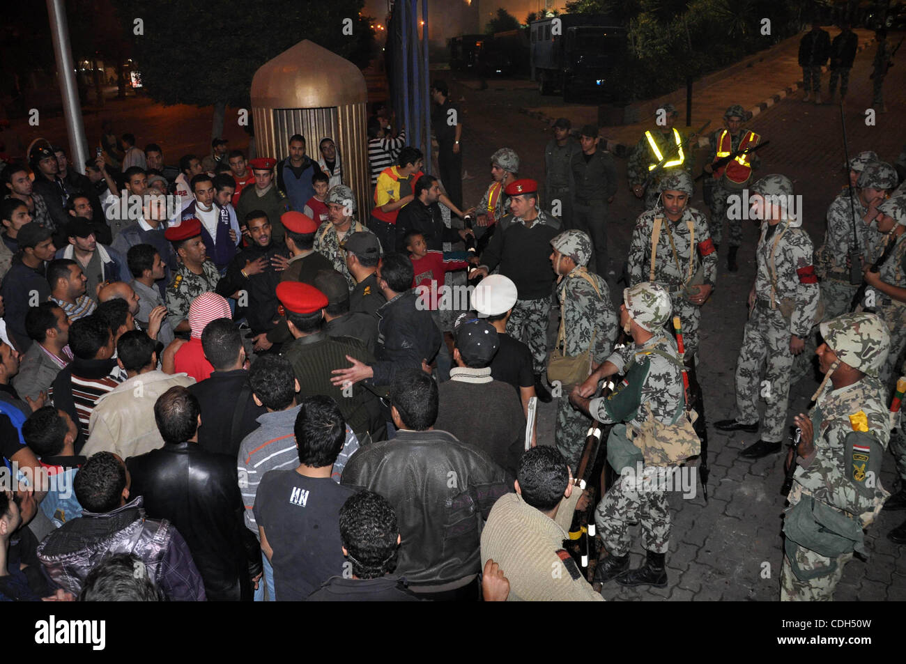 Egyptian protesters are gathered a round Egyptian army soldiers after ...