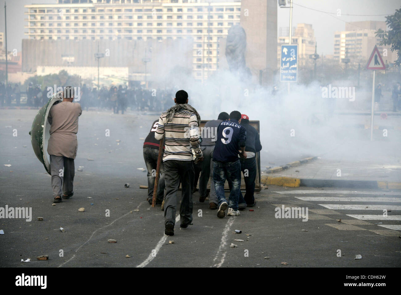Egyptian policemen fire tear gas canisters towards anti-government ...