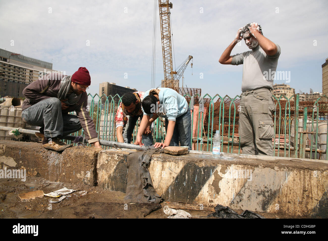 February 6, 2011; Cairo, Egypt. A group of men wash in Tahrir square ...