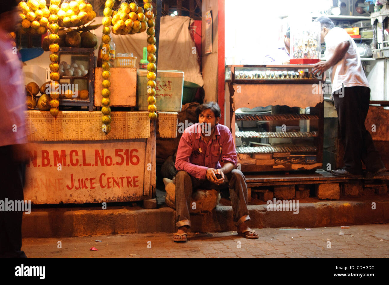 A man sits on the curb in Mumbai, India Stock Photo - Alamy
