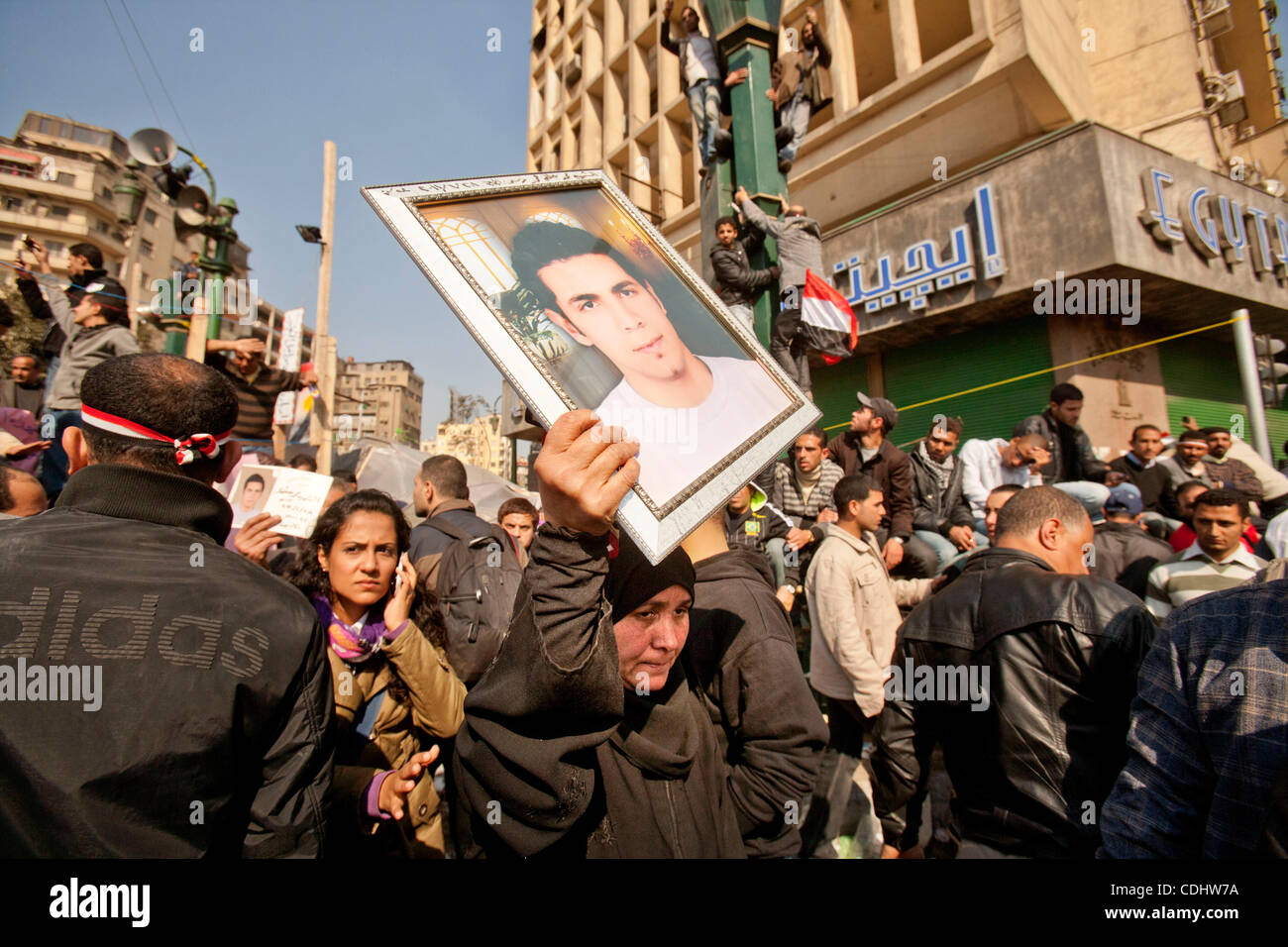 Feb 11, 2011 - Cairo, Egypt - A woman carries the picture of a loved ...