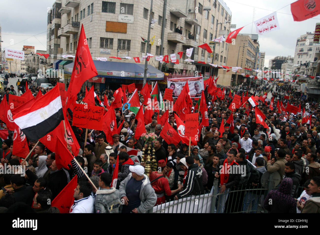 Palestinians wave an Egyptian flag and red flags during a demonstration ...
