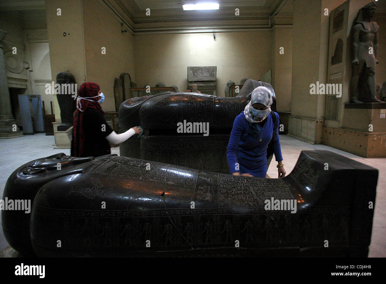 A museum worker cleans in the Egyptian Museum in preparations for its ...