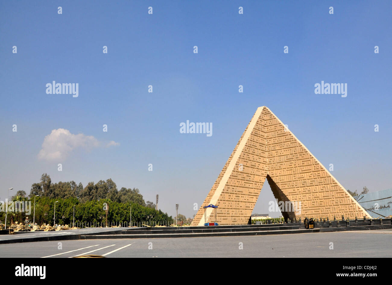 Armored vehicles are seen in front of the memorial stone in Cairo ...