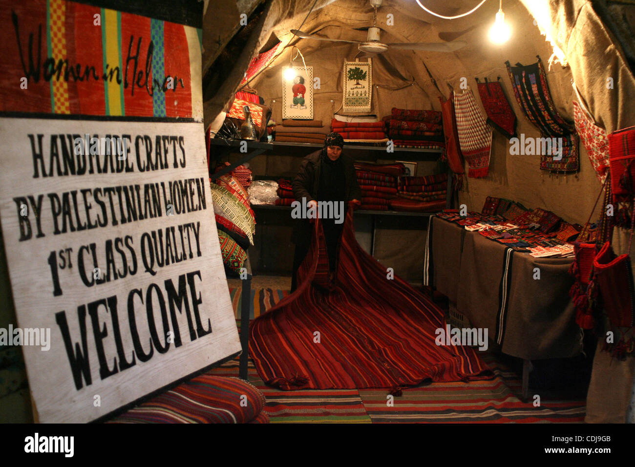 Palestinians shop in a traditional market at the old city in the West ...