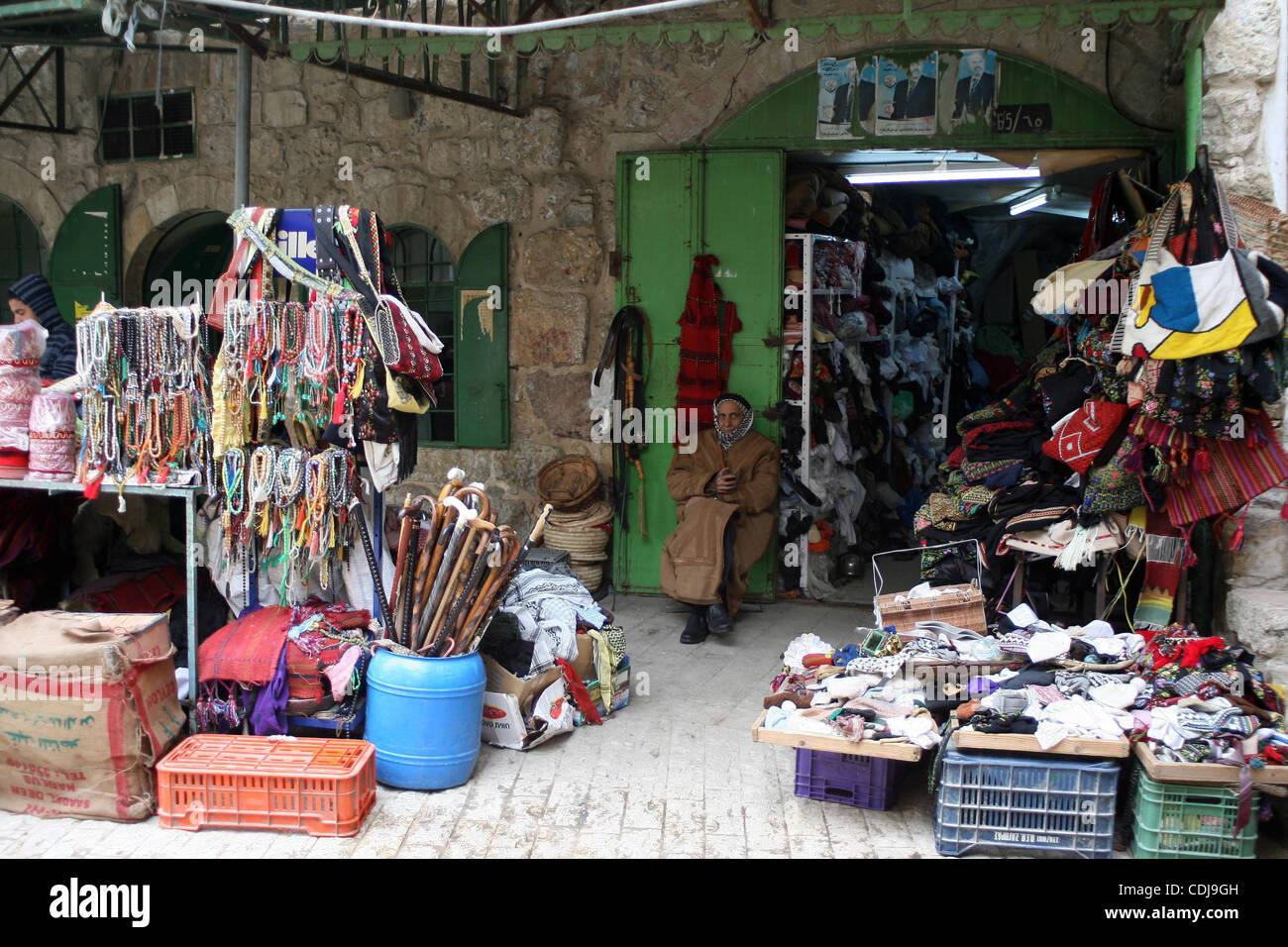 Palestinians shop in a traditional market at the old city in the West ...