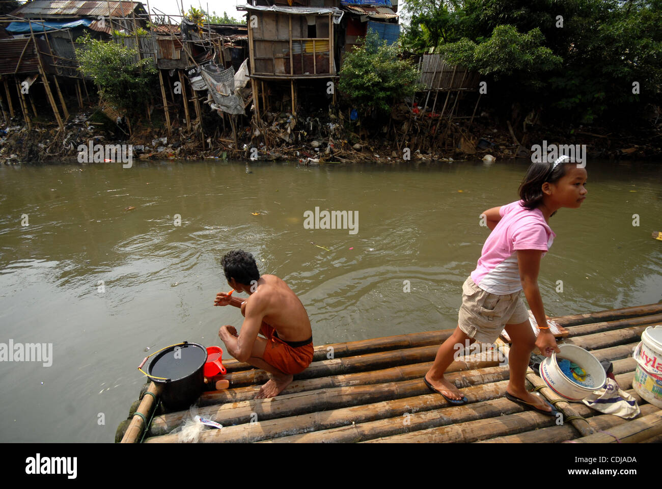 Citizens take a bath and wash in Ciliwung river at a slum area in ...