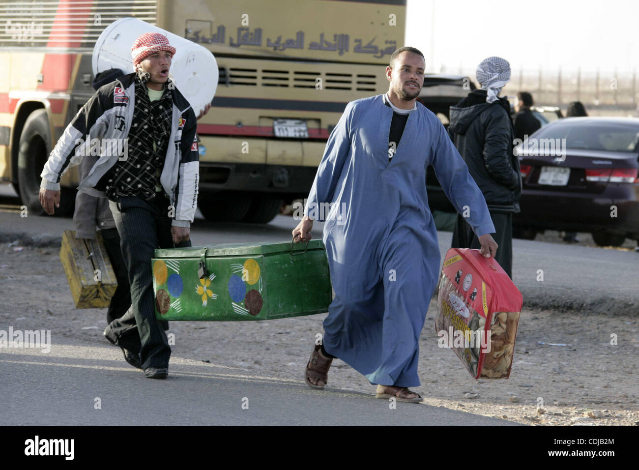 Egyptians, who have fled from Libya through the Salloum land port gate ...
