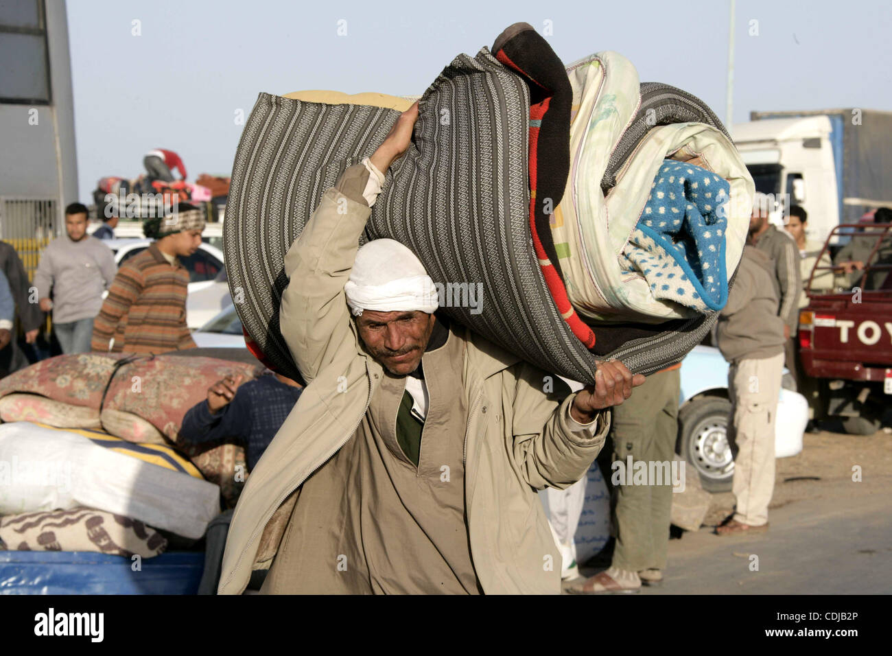 Egyptians, who have fled from Libya through the Salloum land port gate ...