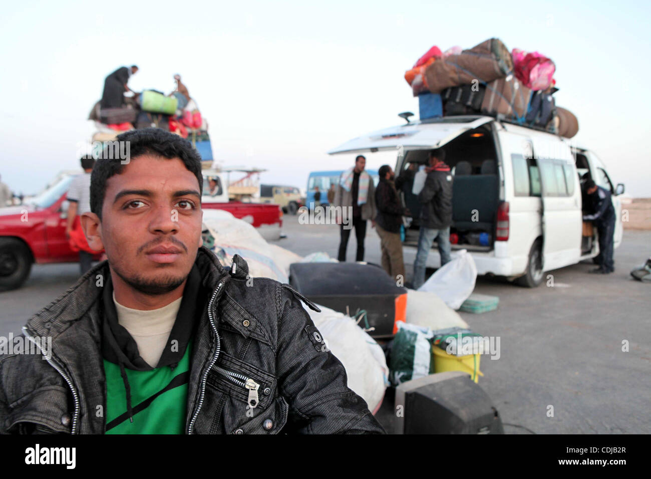 Egyptians, who have fled from Libya through the Salloum land port gate ...