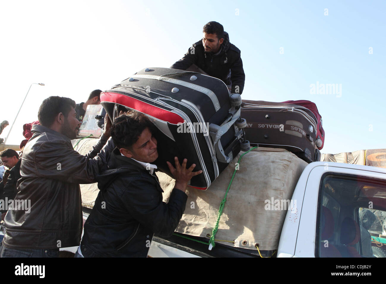 Egyptians, who have fled from Libya through the Salloum land port gate ...