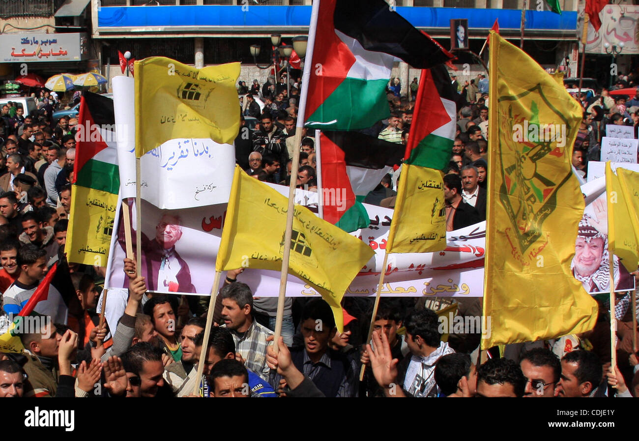 Palestinian protesters hold national and Fatah movement flags and ...