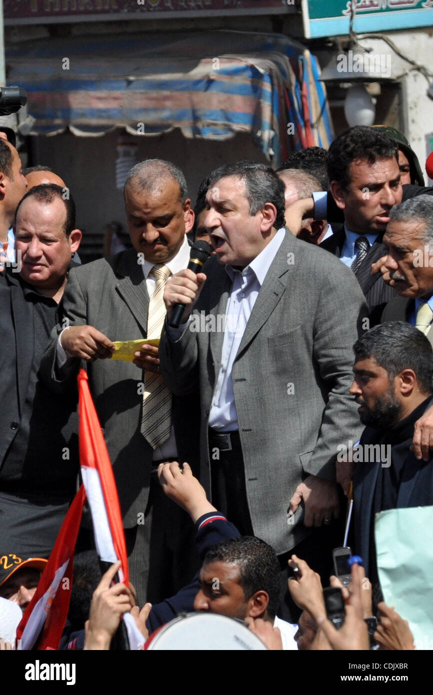 Egyptian Prime Minister designate Essam Sharaf, holding the microphone ...