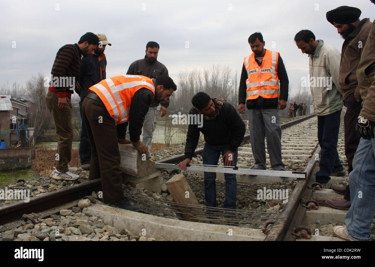 Railway engineers repair the damaged railway track at Nowgam outskirts ...