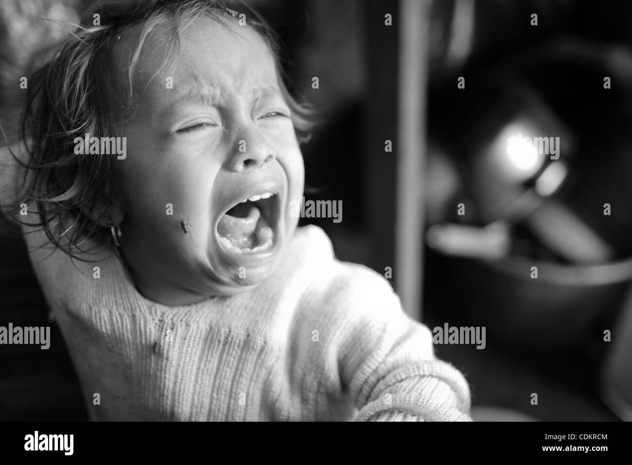 Mar 25, 2011 - Antigua, Guatemala - A young child cries inside her ...