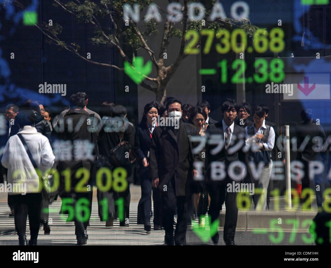 Mar. 29, 2011 - Tokyo, Japan - Japanese businessmen walk past the ...