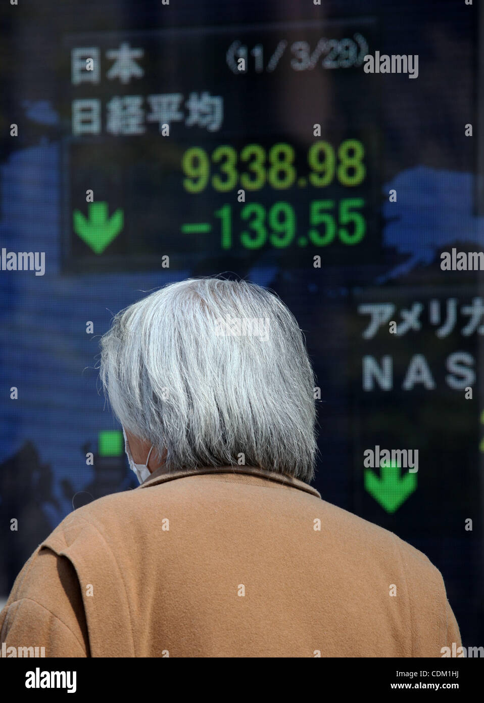 Mar. 29, 2011 - Tokyo, Japan - A Japanese businessmen walks past the ...