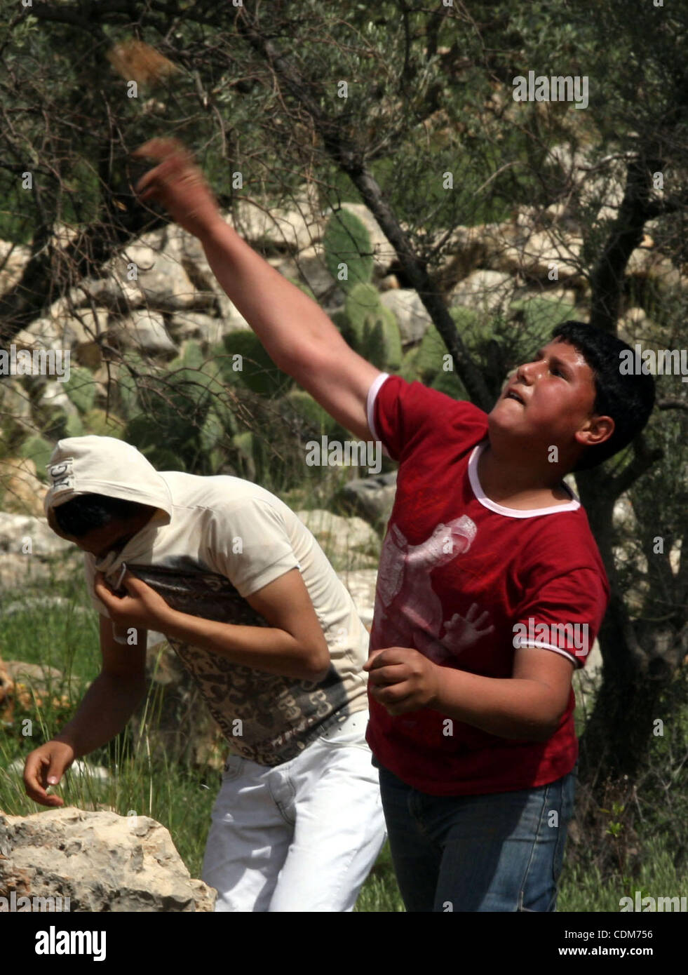 Palestinian demonstrators hurl stones towards Israeli forces during ...