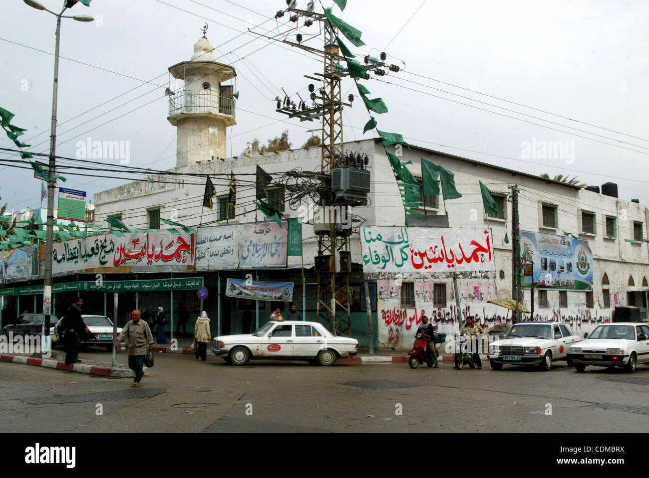 Palestinians walk past posters in Rafah in the southern Gaza Strip, on ...
