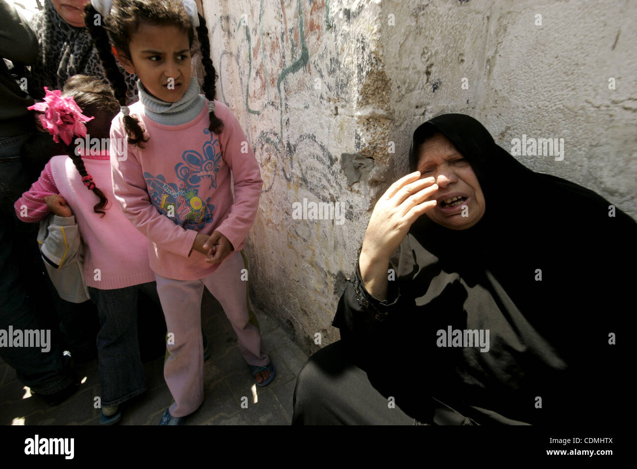 A Palestinian woman mourn at the body of Hamas militant Mohammed Awaja ...