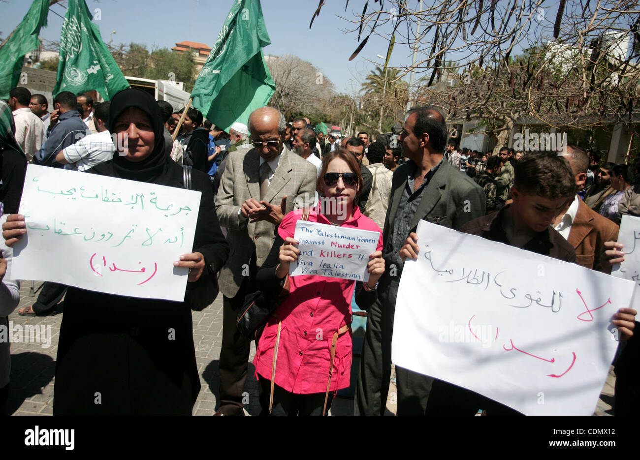 Palestinians hold slogans against the kidnapping and killing of an ...