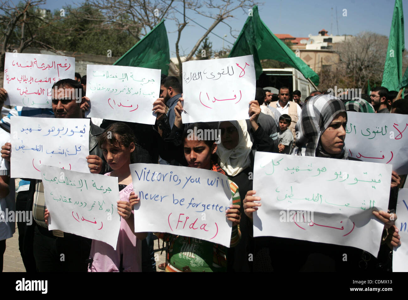 Palestinians hold slogans against the kidnapping and killing of an ...
