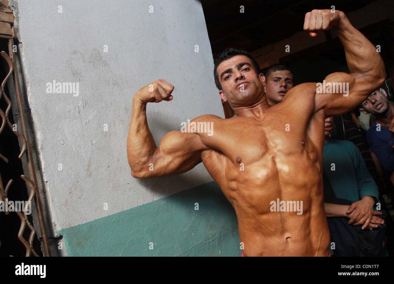 Palestinian men take part during competing in a bodybuilding contest at ...