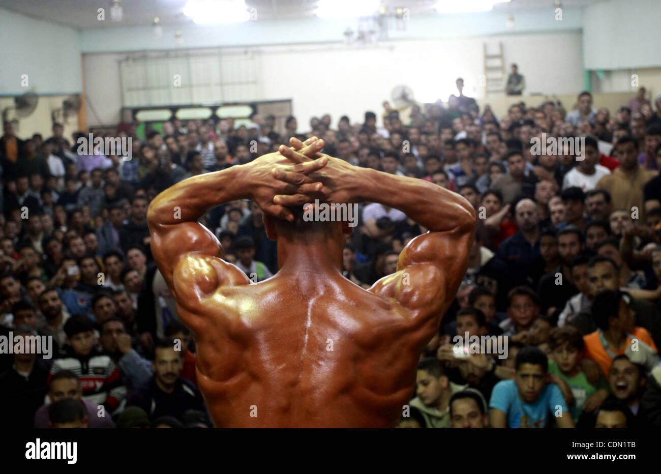 Palestinian men take part during competing in a bodybuilding contest at ...