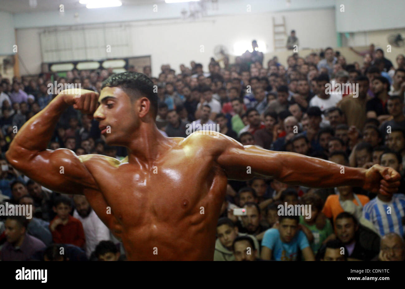 Palestinian men take part during competing in a bodybuilding contest at ...