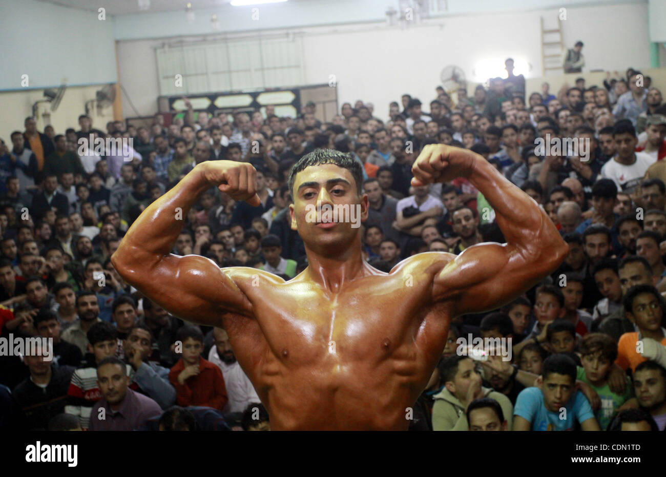 Palestinian men take part during competing in a bodybuilding contest at ...