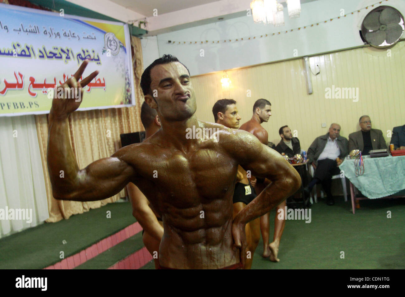 Palestinian men take part during competing in a bodybuilding contest at ...