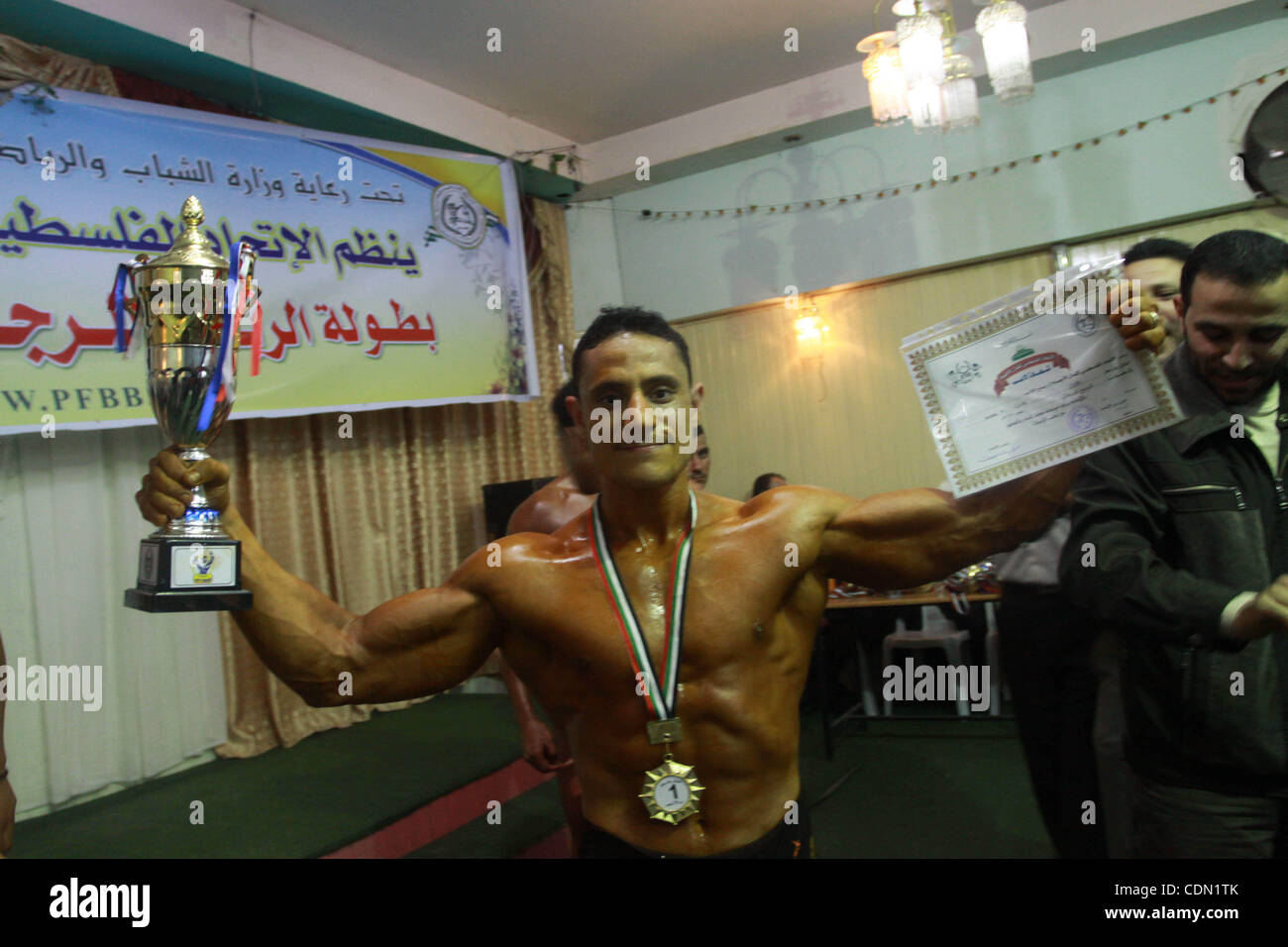Palestinian men take part during competing in a bodybuilding contest at ...